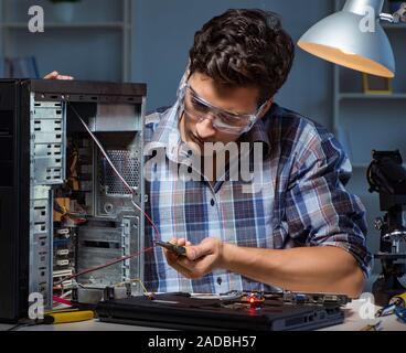 The man repairing computer desktop with pliers Stock Photo - Alamy