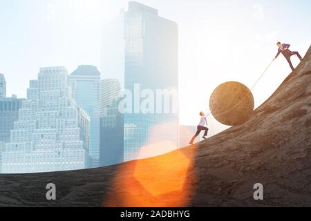 The team of people pushing stone uphill Stock Photo - Alamy