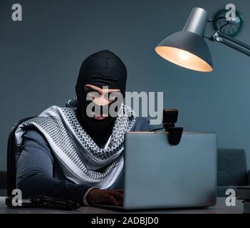 The hacker wearing balaclava mask hacking computer Stock Photo - Alamy