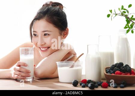 Young women drinking milk Stock Photo - Alamy