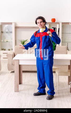 Young contractor doing pest control at home Stock Photo - Alamy