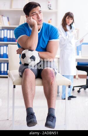 Football soccer player visiting doctor after injury Stock Photo - Alamy