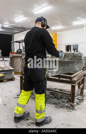 Male working with slates, flat rock, flat stone, from quarry in Pæska ...