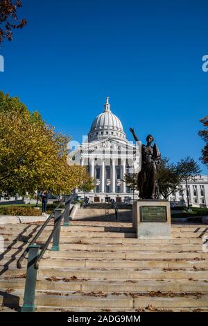 Statue with Wisconsin State Capital building in background. Madison ...