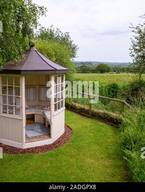 A revolving cream Summer House with view to surrounding countryside ...