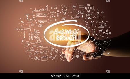 Hand touching hand drawn icons Stock Photo - Alamy