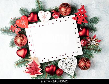 Christmas frame decorated with angel, red scarf, wreath with tree cones ...