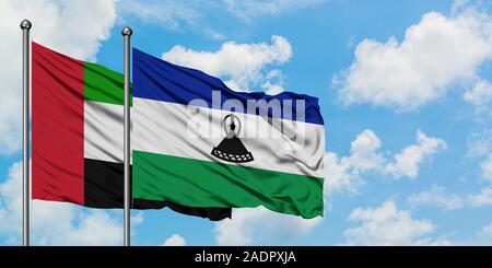 Lesotho and United Arab Emirates flag waving in the wind against white ...