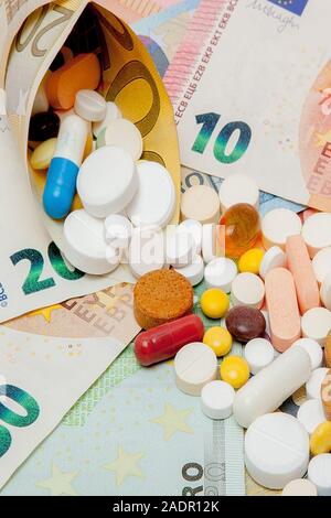 The tablets wrapped in euro with euro banknotes on a pink background ...
