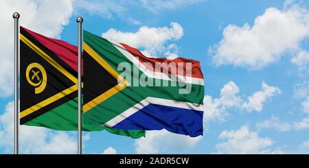 South Africa and Vanuatu flag waving in the wind against white cloudy ...