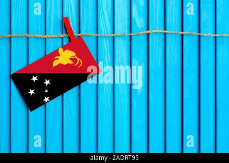 Flag of Guinea hanging on clothesline attached with wooden clothespins ...