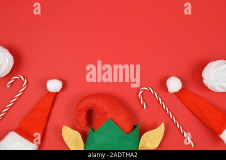 Santa hats with candy canes on light background Stock Photo - Alamy