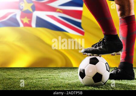 Niue flag on ball at corner kick position, soccer field background ...