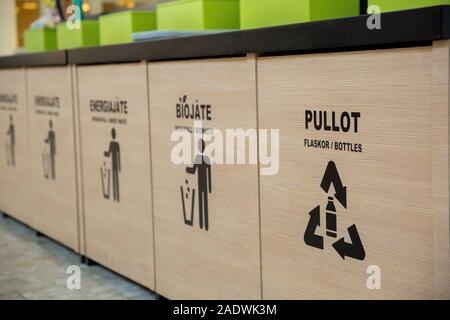 Trash bins in public area next to fast food restaurant, separating ...