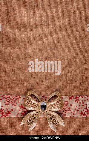 Burlap bow with gold glitter on purple background, Christmas holiday ...