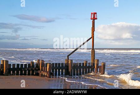 A view of a timber breakwater sea defence on the Norfolk coast at ...