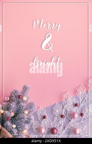 White winter twig with shiny geometric leaves and artificial Xmas tree ...