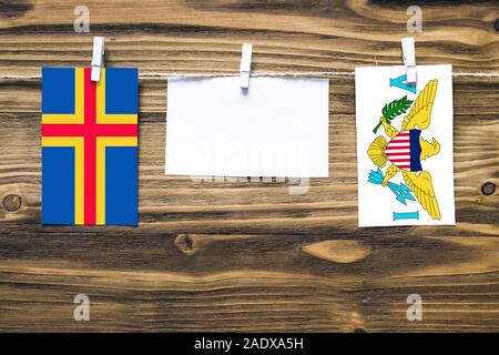 Flag of Aland Islands hanging on clothesline attached with wooden ...