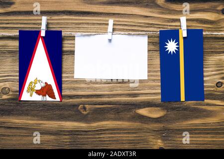 Hanging flags of Nauru and Samoa attached to rope with clothes pins ...