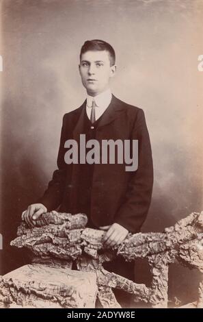 A vintage portrait of a young man, male model, posing in a white t ...