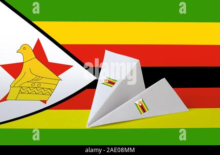 Zimbabwe flag depicted on paper origami crane wing. Oriental handmade ...