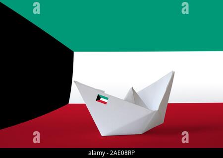 Kuwait flag depicted on paper origami ship closeup. Oriental handmade ...