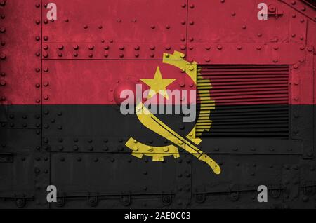 Angola flag depicted on side part of military armored tank close up ...