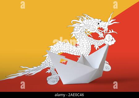 Bhutan flag depicted on paper origami ship closeup. Oriental handmade ...