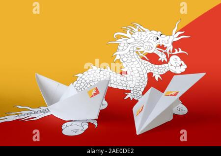 Bhutan flag depicted on paper origami airplane. Oriental handmade arts ...