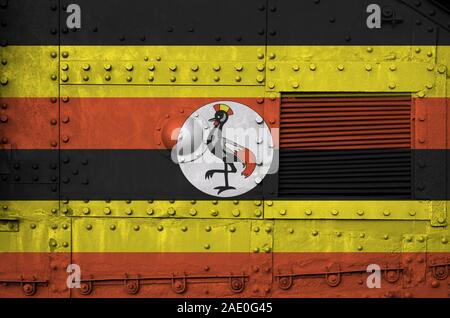 Uganda flag depicted on side part of military armored helicopter close ...