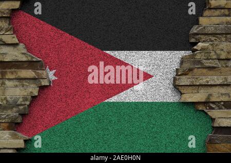 National flag of Jordan on stone wall background. Flag banner on stone ...