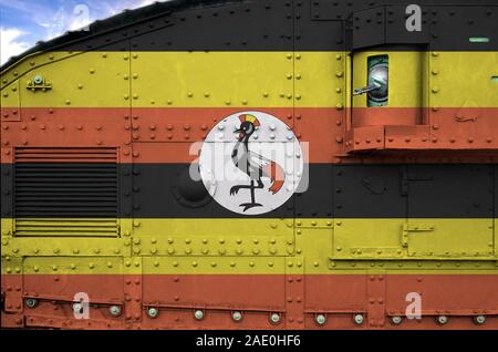 Uganda flag depicted on side part of military armored helicopter close ...