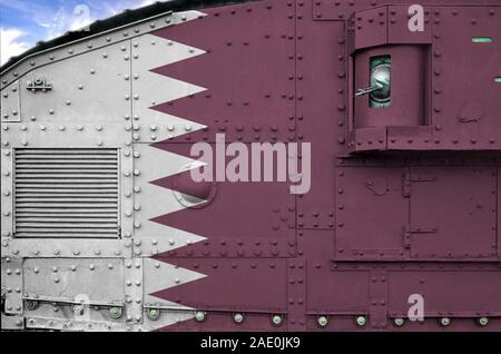 Qatar flag depicted on side part of military armored tank close up ...