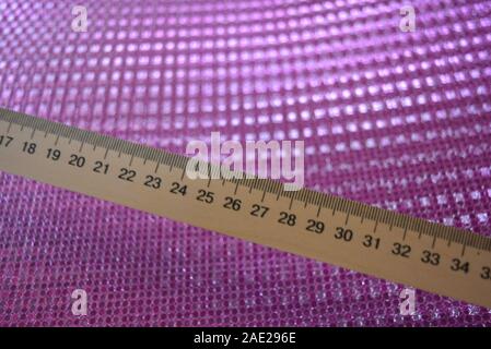 Light wooden mathematical ruler on a pink reflective background Stock ...
