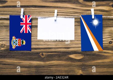Flag of Cayman Islands hanging on clothesline attached with wooden ...