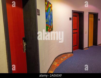 Coloured doors and corridor inside the artHOTEL in Hundertwasser Green ...