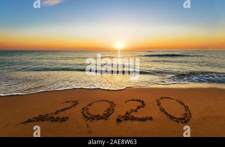 2020 written on the sand of a beach, travel 2020 new year concept Stock ...