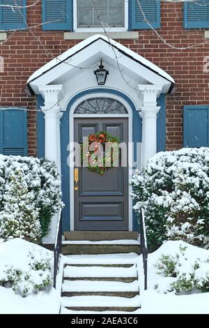 Front door with Christmas wreath and snow, horizontal Stock Photo - Alamy