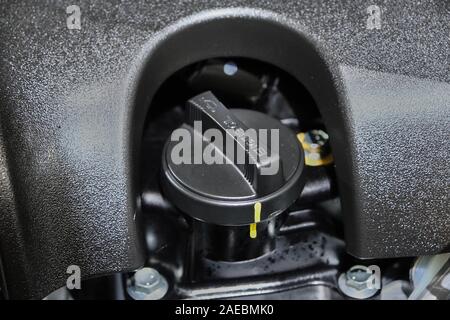 Closeup engine oil cap in engine room of a modern car. Oil cap on the ...