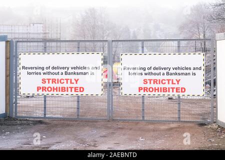 Reversing of delivery vehicles safety sign on fence at construction ...