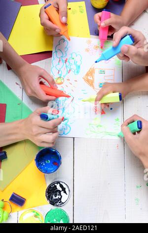 Markers in male and female hands draw on white paper Stock Photo - Alamy