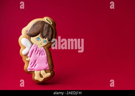 gingerbread cookie of little cute angels on red background. Traditional ...