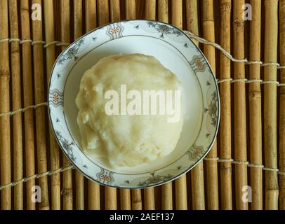 Fufu , mixing and pounding separate equal portions of cassava and green ...
