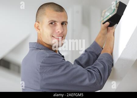 technician placing an emergency exit sign Stock Photo - Alamy