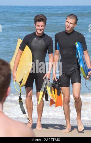 Silhouette surfer bodyboard man on beach at sunset, male body surfer ...