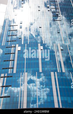 Reflection of a cloudy sky in glass wall of an office building Stock ...