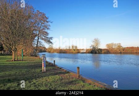 A view of the River Yare with boat moorings on the Norfolk Broads in ...