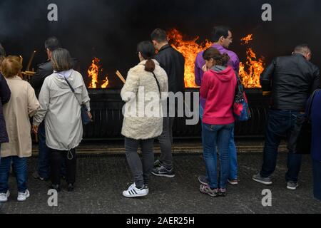 People throwing candles in fire at the Fatima Shrine, Fatima, Ourem ...