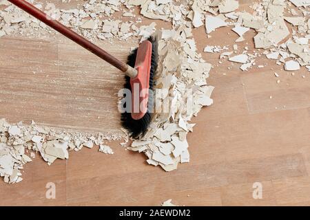 Builder sweeping the floor after renovation Stock Photo - Alamy