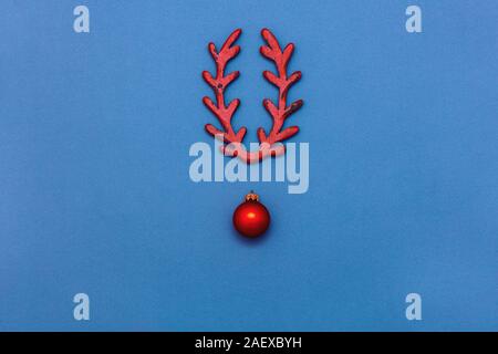 Red Christmas reindeer horns on blue background Stock Photo - Alamy
